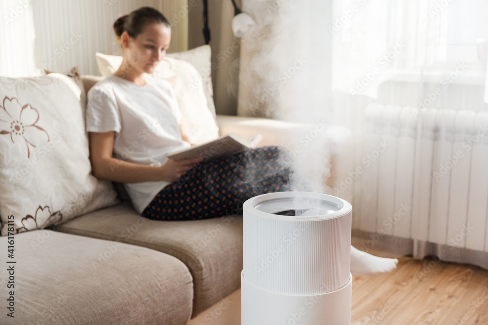 Modern air humidifier, aroma oil diffuser at home. Improving the ...