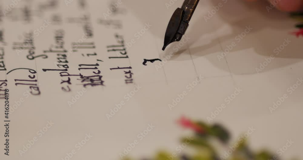 Man hand writing a embellished letter with calligraphy gothic letters ...