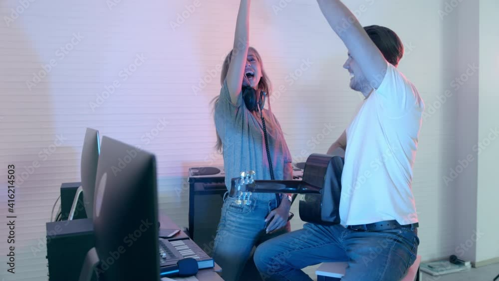 Wide shot - Young Caucasian female singer composer and a Caucasian male ...