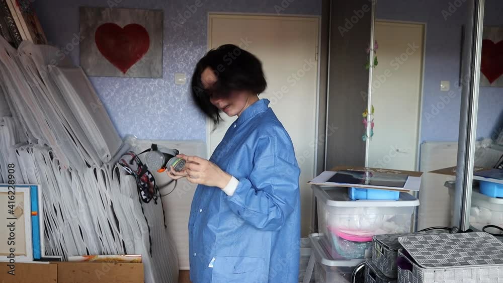 Talent woman artist take off respirator from faces after working in art ...