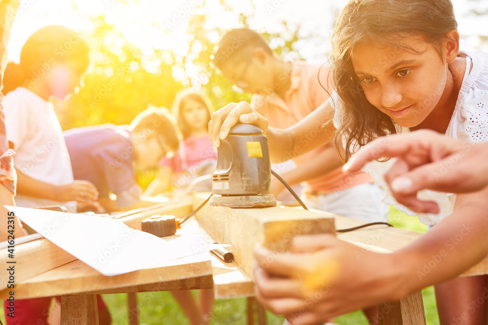 Group of children learning to work at summer camp Stock Photo | Adobe Stock