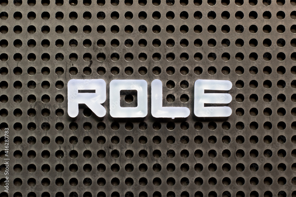 White color letter in word role on black pegboard background Stock ...