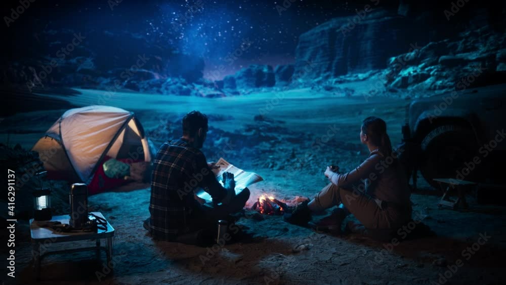 Happy Couple of Hikers Camping in the Canyon at Night Together, Sitting ...
