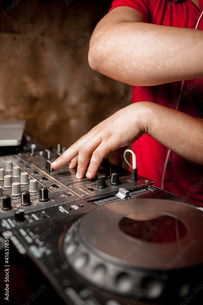 The DJ's hand on the DJ mixer. Dj on the turntables. DJ's hand on a DJ ...