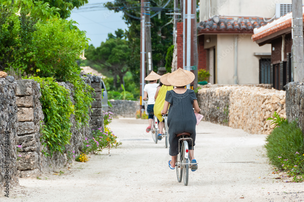Foto de Three people riding bicycles, one after the other, strolling ...