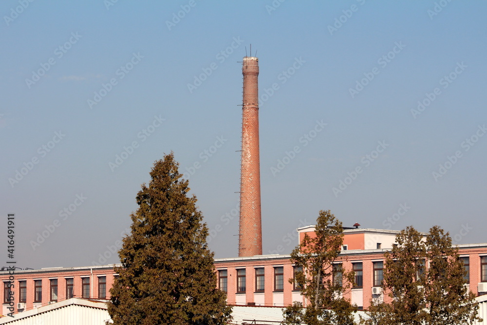 Red bricks tall industrial chimney with metal stairs mounted on side ...