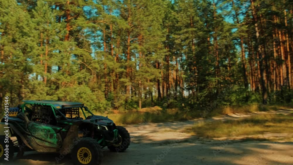 Cinematic clip of a buggy car is driving in cross country road. Buggy ...