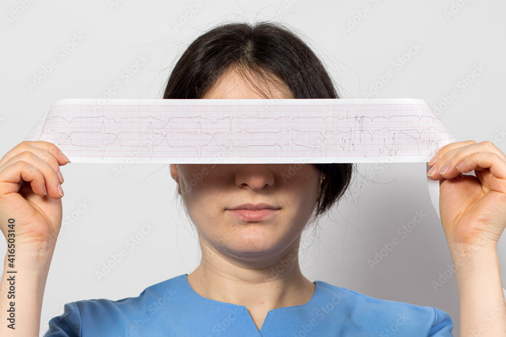 The cardiologist shows the film of an electrocardiogram of a patient ...