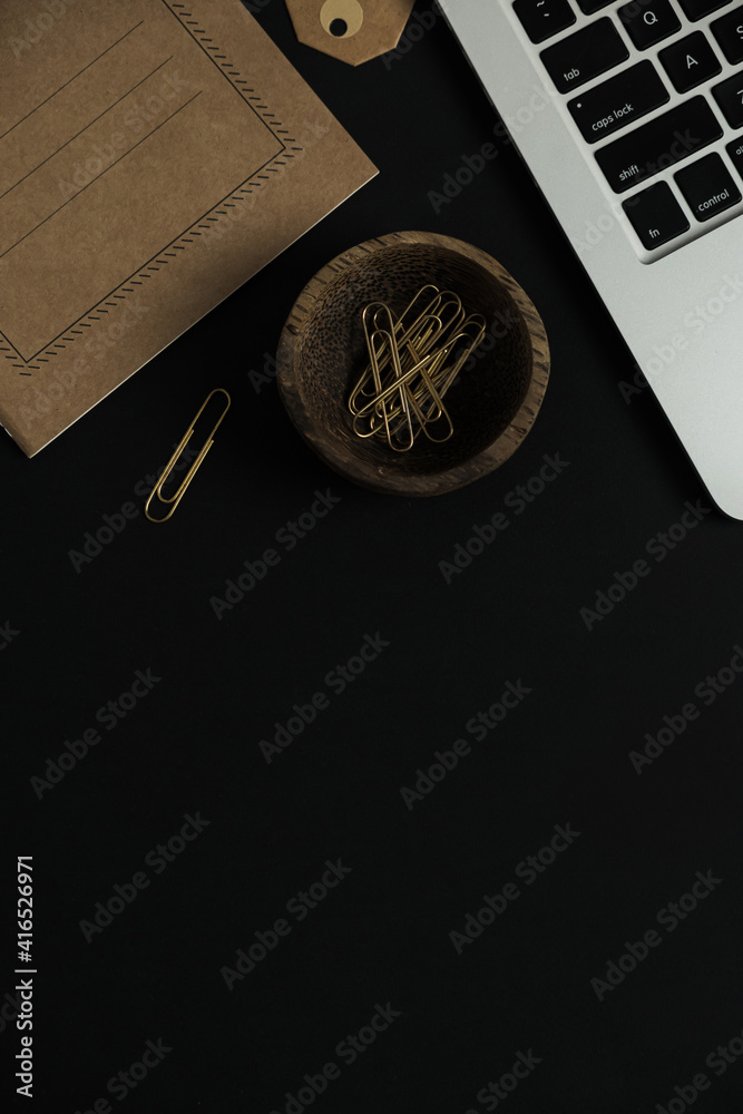 Black background office workspace desk with laptop computer, craft ...