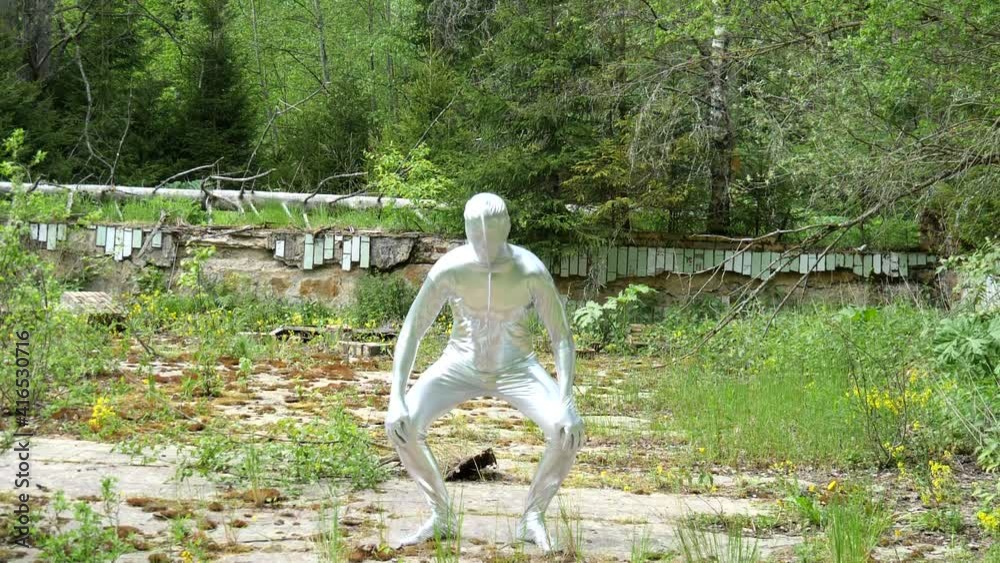 Tall slender man in silver suit is fully dressed in tight silver suit ...