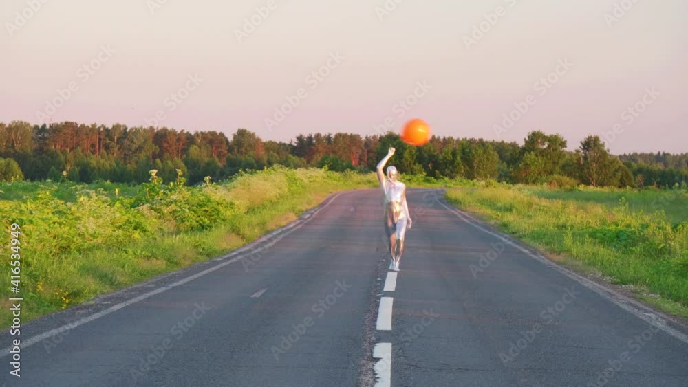 Tall slender man in silver suit is fully dressed in tight suit, running ...