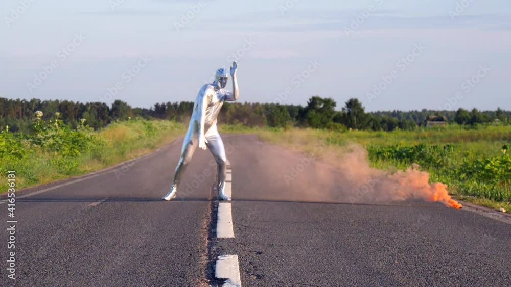 Tall slender man in silver suit is fully dressed in tight silver suit ...