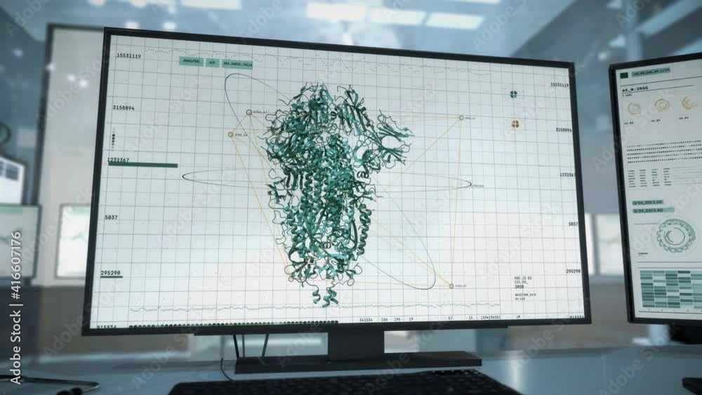 Two computer monitors with keyboard on desk. Data and 3D image on ...