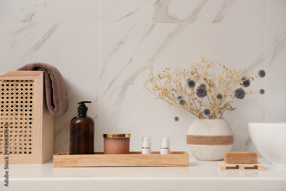 Personal hygiene products and toiletries on table near white wall in ...