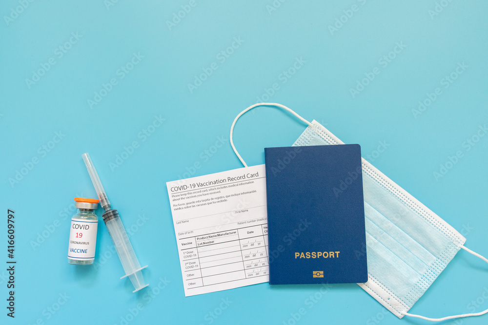 Doctor is holding a vaccination record card and corona virus vaccine ...