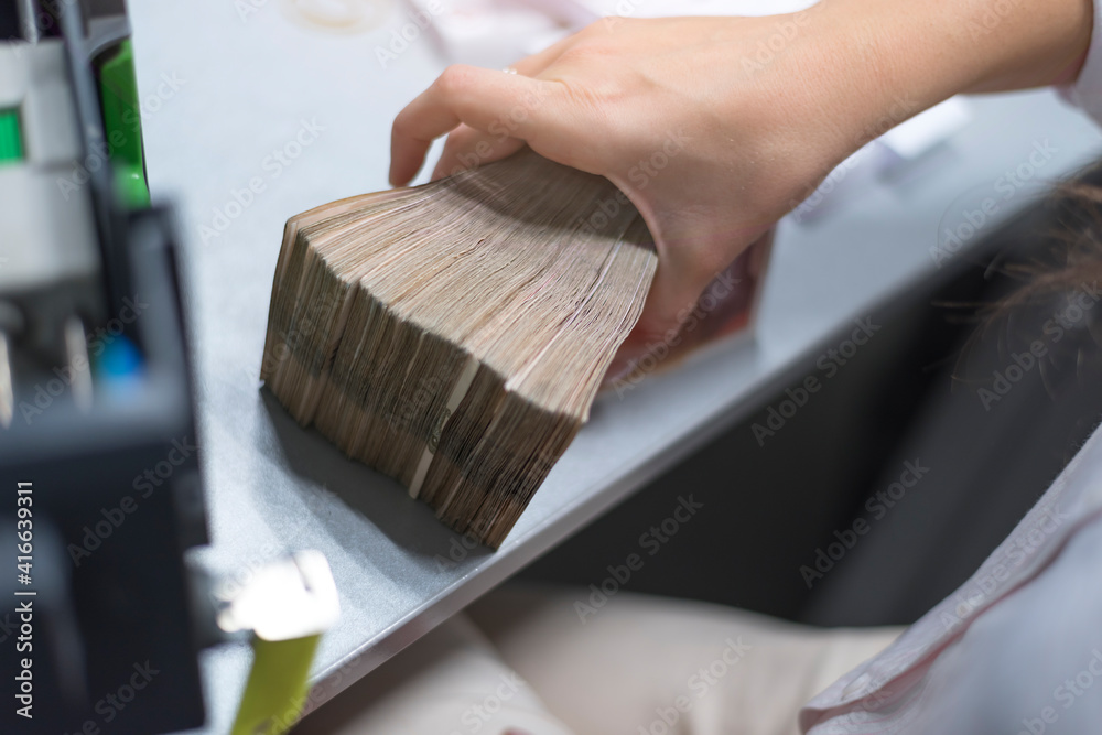 Bank employees sorting and counting money inside bank vault. Large ...