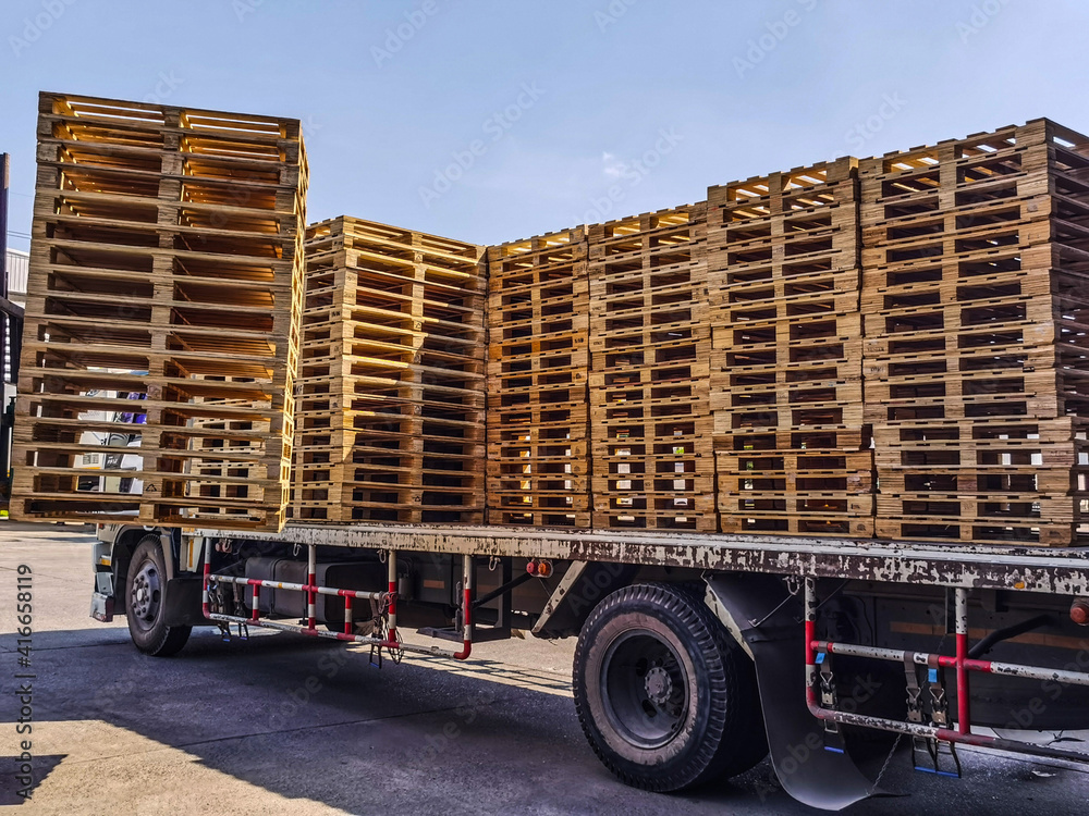 Worker driving forklift to loading and unloading wooden pallets from ...