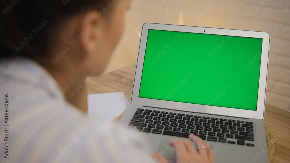 The concept of distance learning, work. Green computer screen. The girl ...