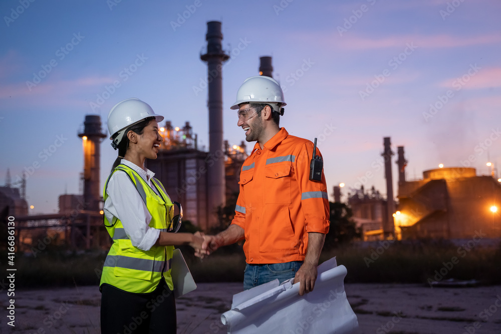 Refinery industry engineer shaking hands while working for teamwork in ...