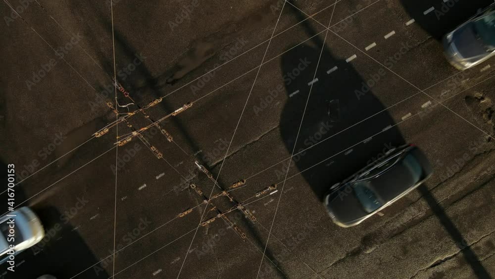 Top down view of street crossing with traffic, trolleybus wires ...