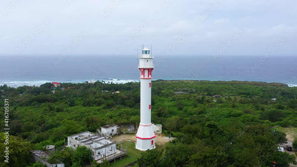 Lighthouse on a hill near the sea. Ocean coast with rainforest and ...