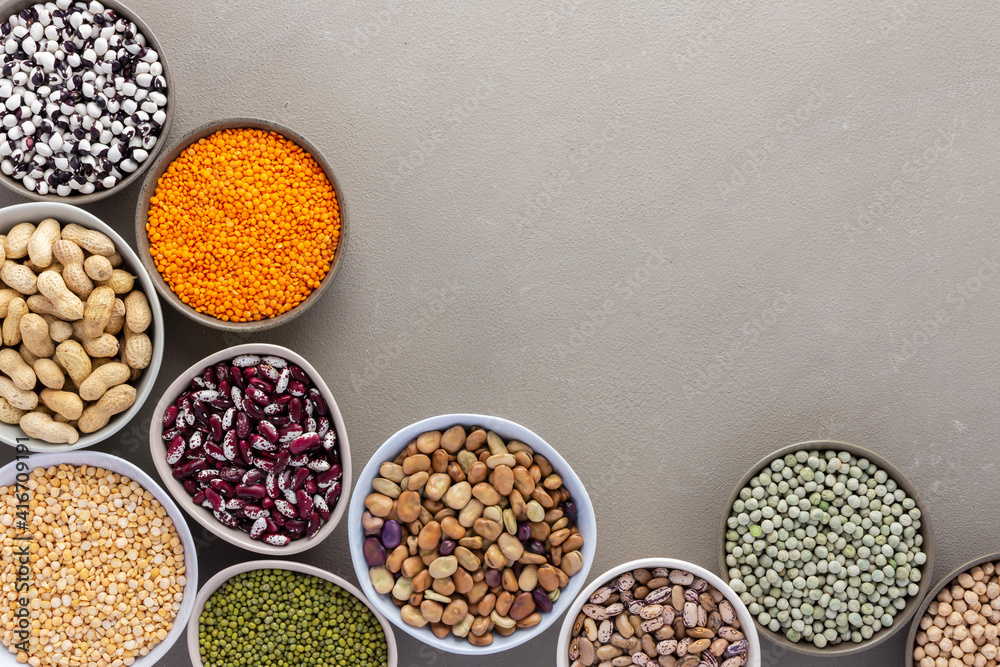 Different types of legumes in bowls, green and yellow peas, chickpeas ...