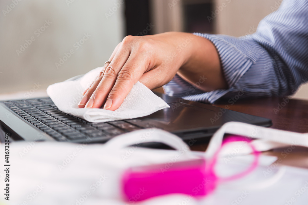 Hands disinfecting laptop keyboard using wet disinfectant wipes. Stock ...