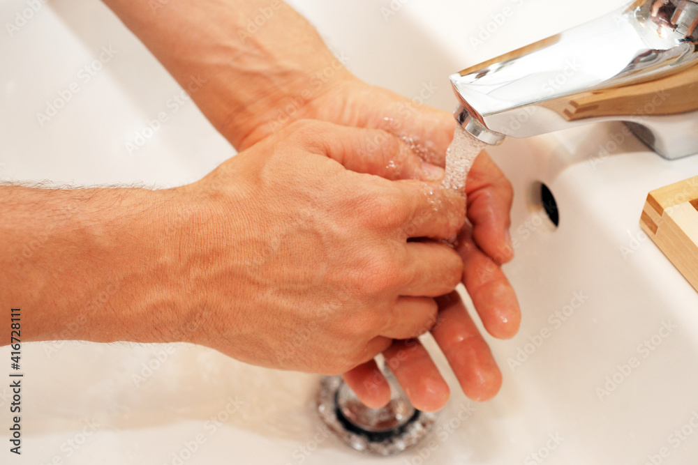 Wash hands close up- male hands using soap and tap water concept hand ...