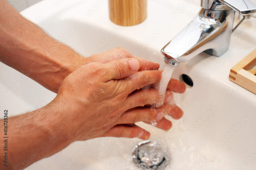 Wash hands close up- male hands using soap and tap water concept hand ...