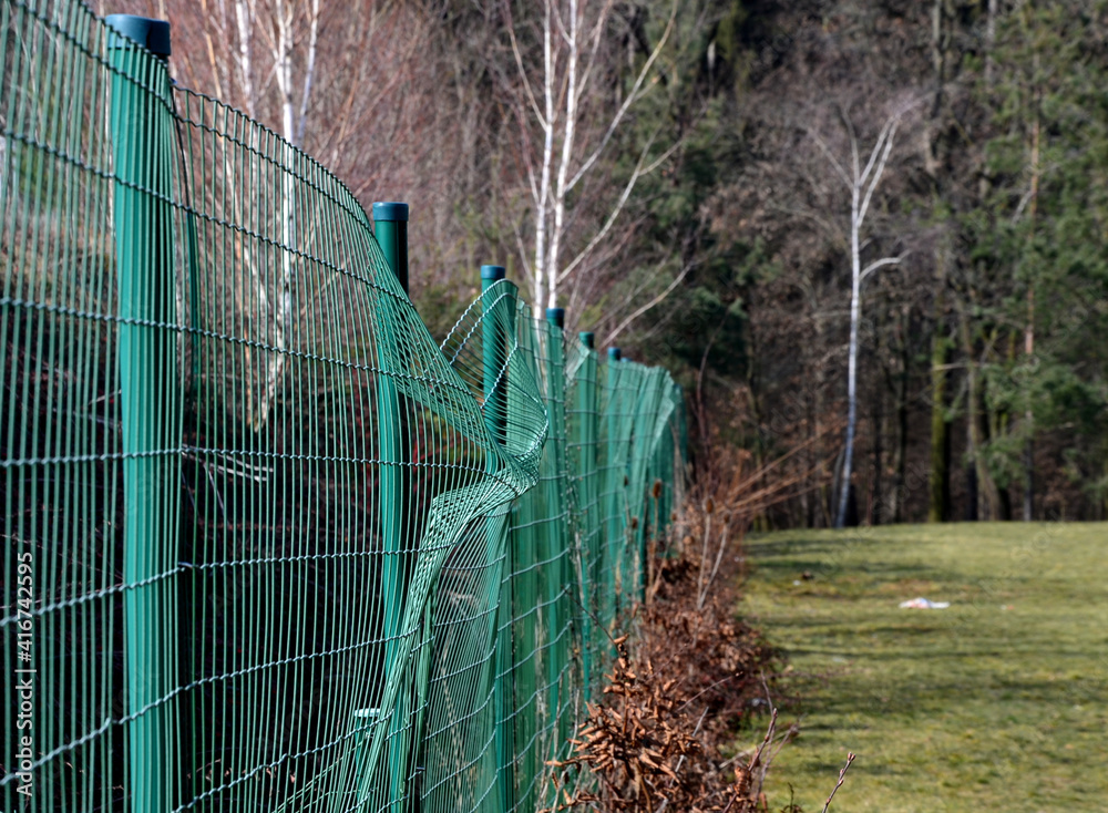 damaged wire fence, through which got thief or curious man, child. bent ...