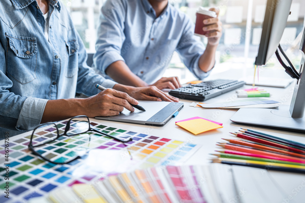 Two colleague creative graphic designer working on color selection and ...