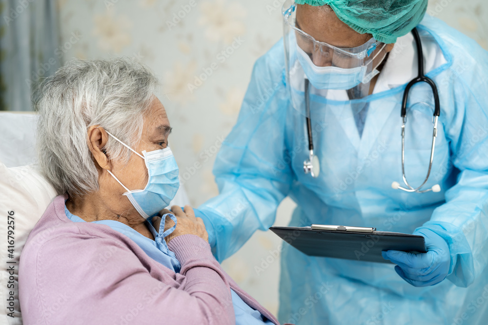 Asian doctor wearing face shield and PPE suit new normal to check ...