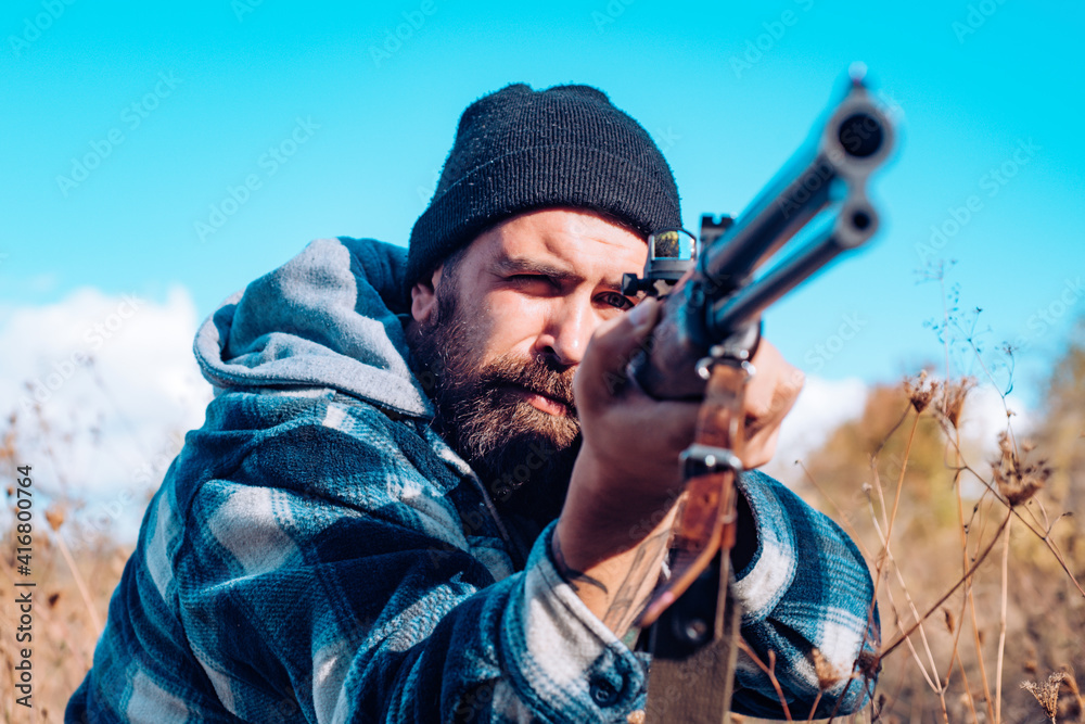 Hunter man hunting in America with shotgun gun on hunt. Aiming rifle in ...