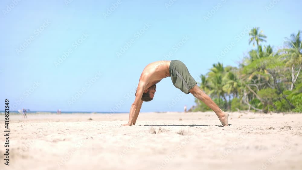 Young healthy millennial man practice yoga pose on the beach. Concept ...