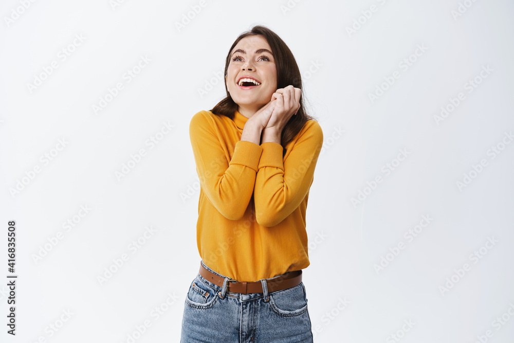 Romantic young girl holding hands clenched together and admire ...