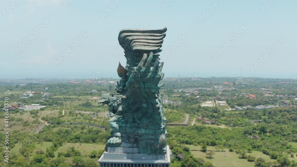 Side view of huge copper statue in Bali, Indonesia. Garuda Wisnu ...