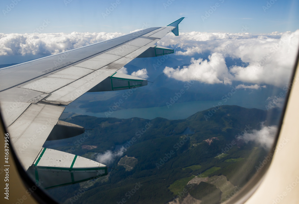 mountains, lakes and rivers outside a plane window. Travel time, sky ...