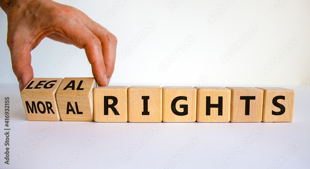 Moral or legal rights symbol. Businessman turns wooden cubes and ...