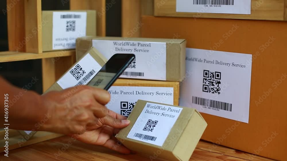 Selective focus to QR code of parcel delivery tag on smartphone to scan ... Selective focus to QR code of parcel delivery tag on smartphone to scan ...