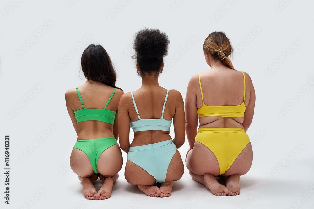Rear View Of Beautiful Diverse Young Women In Colorful Underwear