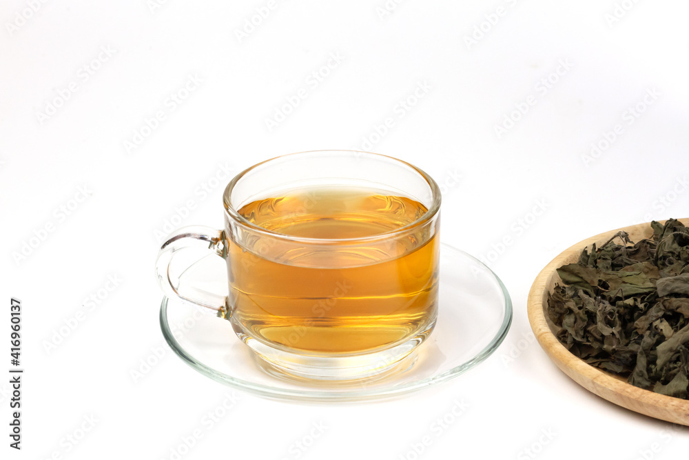Tulsi or holy basil tea in transparent cup with dried tulsi leaf on ...