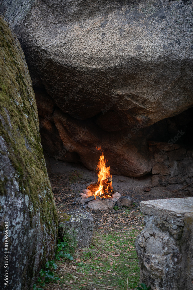 Fire pit bonfire on the middle of boulders stones full with moss in ...