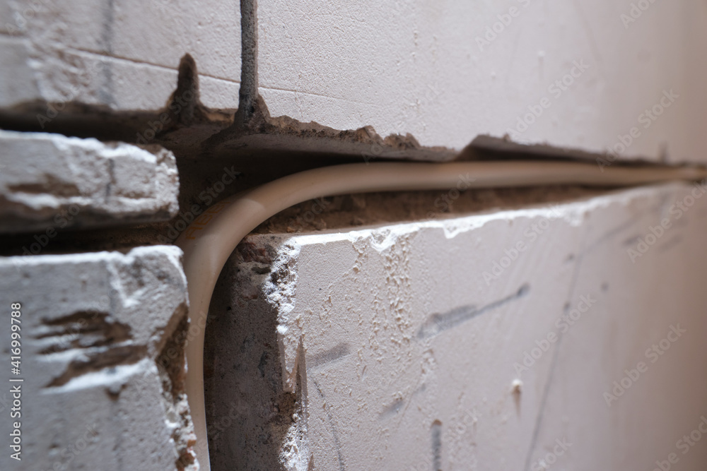 A sample of laying an electric cable into a concrete wall of an ...