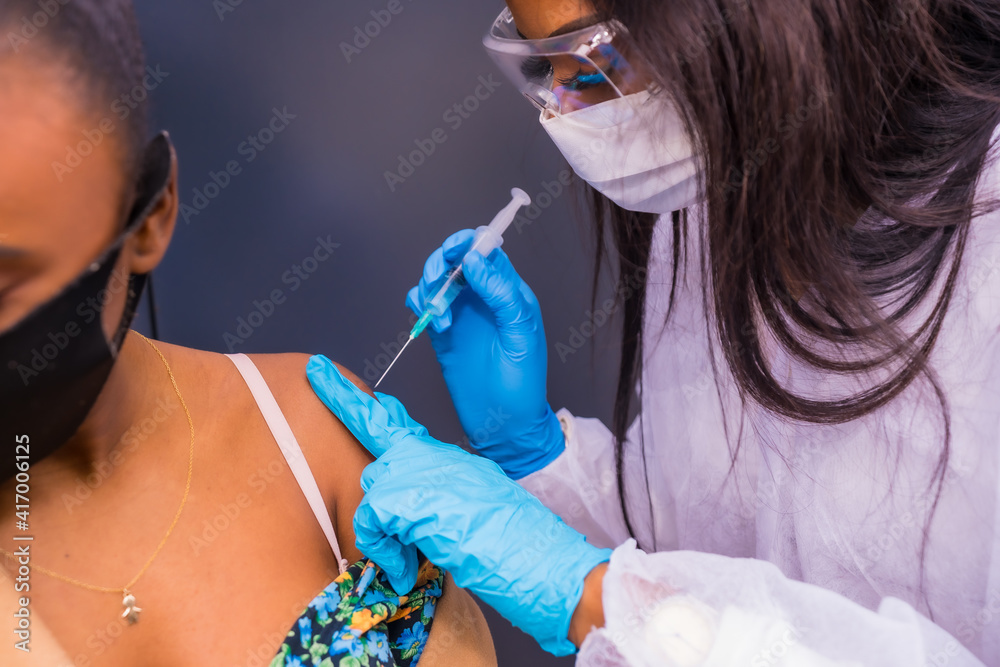 Detail of the vaccination in a black African ethnic girl, immunizes the ...