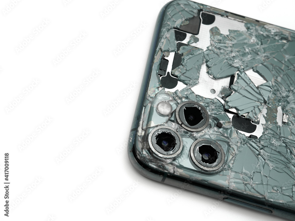 Top view the back of midnight green modern smartphone with a broken ...