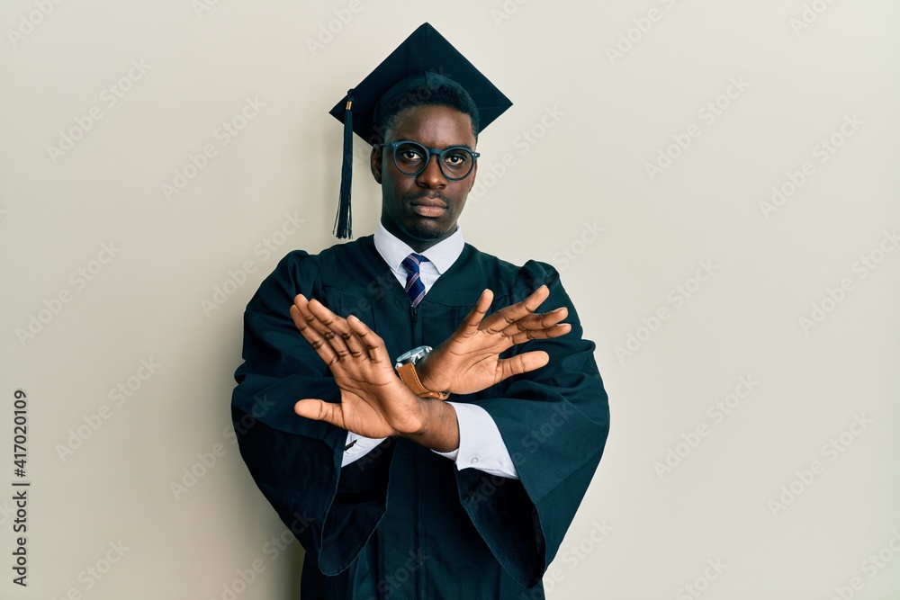 Handsome black man wearing graduation cap and ceremony robe rejection ...