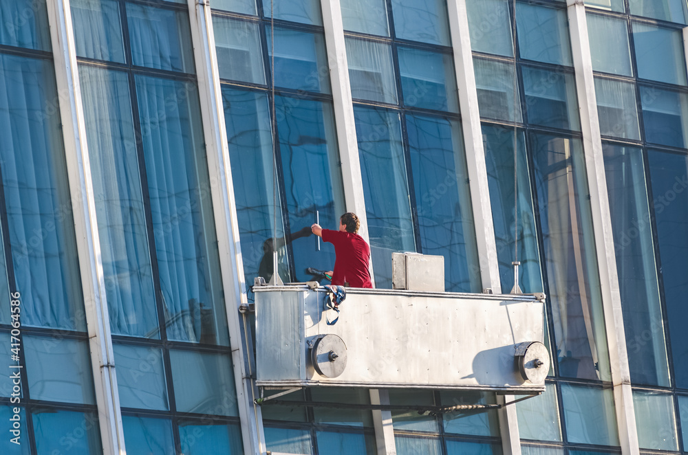 Window washer cleaning the glass facade Stock Photo | Adobe Stock