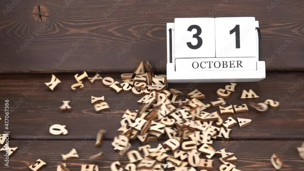 October 31, date on the calendar. Handmade wood cube with date month ...