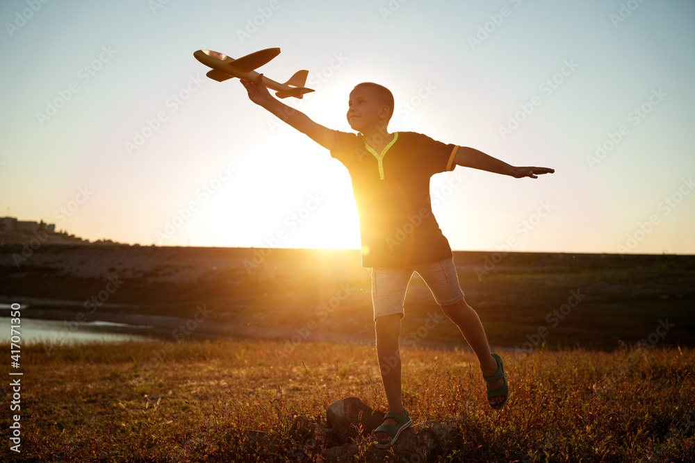 boy launches the plane on a background of sunset sky Stock Photo ...