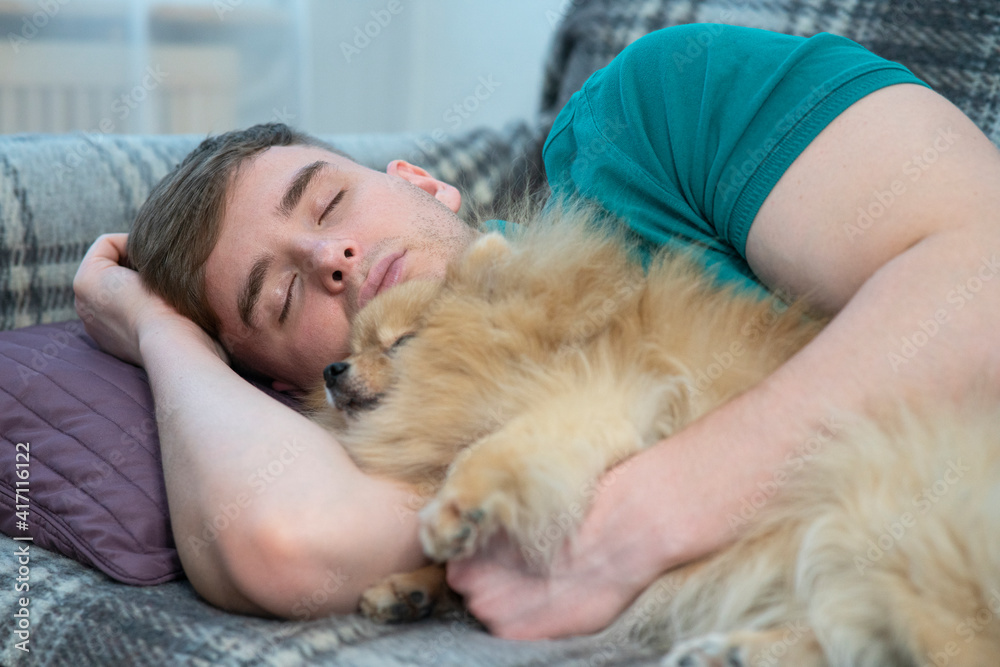 Handsome guy, young man is lying with eyes closed, sleeping, taking a ...